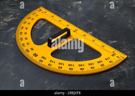 Protractor with measuring length and degree markings on blackboard, top ...