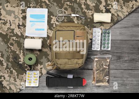 Flat lay composition with military first aid kit on light grey table ...