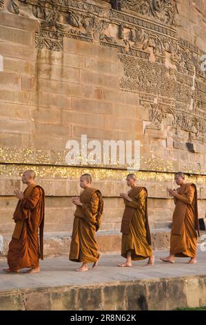 Praying Buddhist monks circling the Dhamekh Stupa, Isipatana Deer Park ...