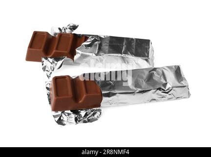 Delicious chocolate bars wrapped in foil on light blue background ...