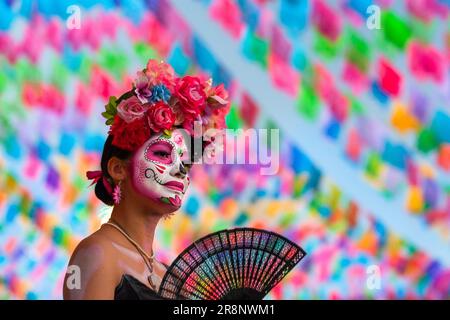 Young woman fanning herself with hand Stock Photo - Alamy