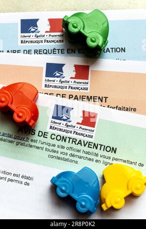 Colorful toy cars placed on French administrative documents featuring ...
