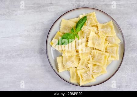 Plate with tasty pasta on grey table Stock Photo - Alamy