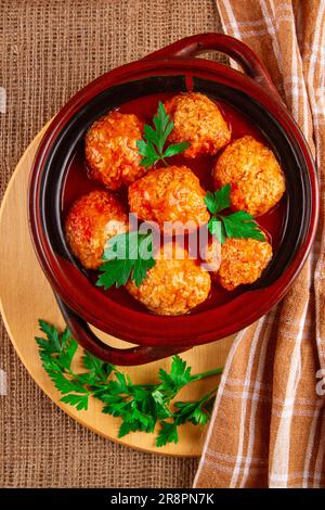 Classic meatballs drenched in savory tomato sauce on vibrant striped ...