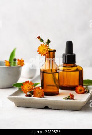 essential oils with herbal flowers Stock Photo - Alamy