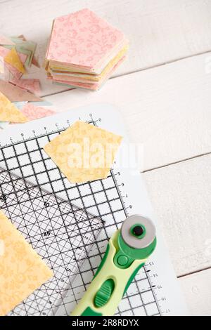 Stack of pentagon pieces of fabrics on white craft mat Stock Photo - Alamy