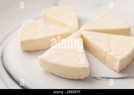 Plate with triangles of tasty processed cheese, cherry tomatoes and ...