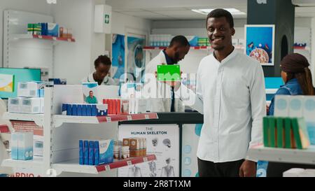 Male doctor holding medicaments and using laptop in clinic Stock Photo ...