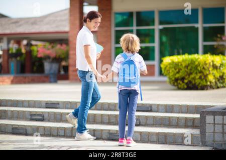 Mother bringing child to school. Parents pick up little boy after class ...