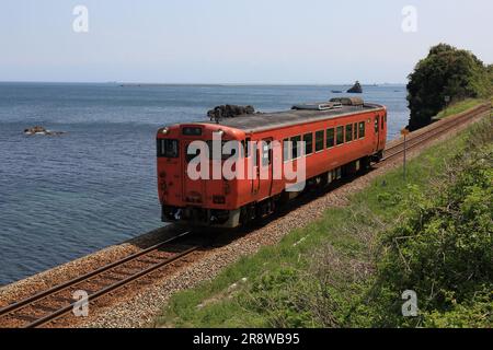 Train of Himi line running along Amaharashi coast Stock Photo - Alamy