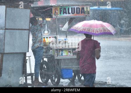 Shop keepers arranging their shop during heavy rains in Agartala ...