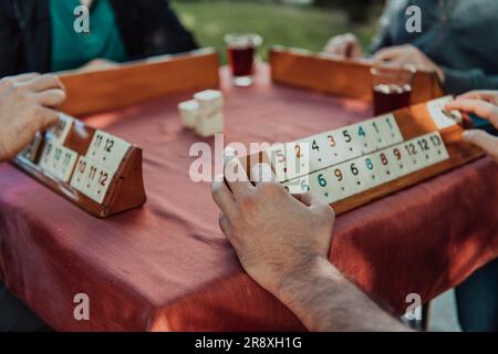 A group of men drink traditional Turkish tea and play a Turkish game ...