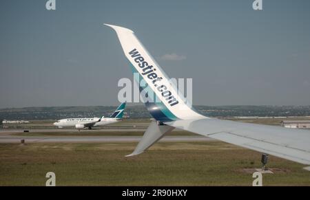 Westjet airplanes on the service ramp at Calgary Airport in Alberta ...