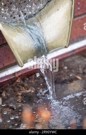 Water exiting a drain spout Stock Photo - Alamy