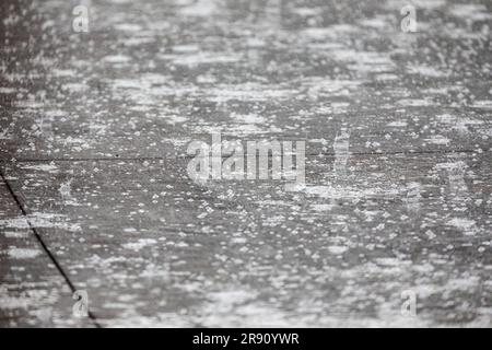 Rain splattering on pavement with small pieces of hail Stock Photo - Alamy