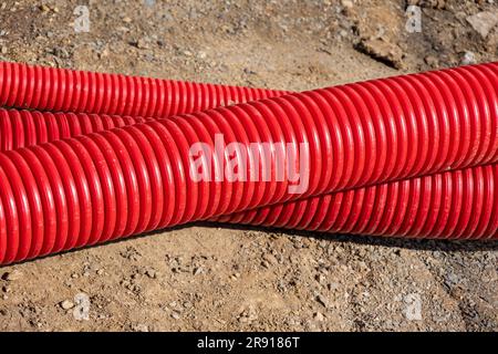 Red plumbing pipe close-up. Drainage, tubing, pipes. Red pipes of the ...