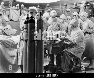 in a large operating theatre a surgical operation is performed by two ...