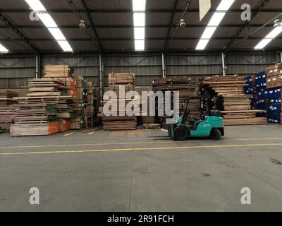Forklift working in lumber warehouse Stock Photo - Alamy