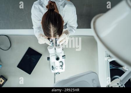 Young female Laboratory scientist working at lab with test tubes and ...
