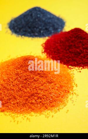 Heaps of different bright food coloring on pink background, flat lay ...