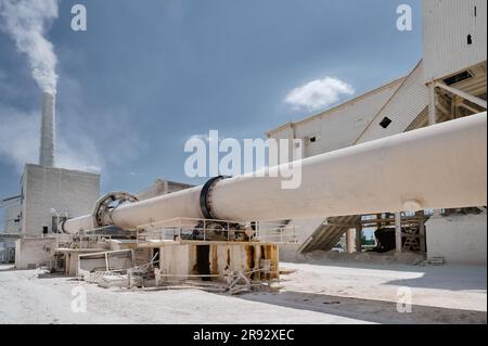 Tubular rotary furnace and smoking chimney at factory Stock Photo - Alamy