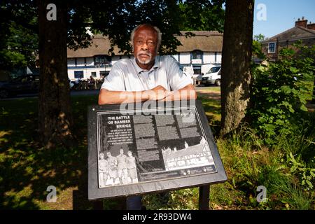 Clinton Smith, chair of Preston Black History Group reads a copy of a ...