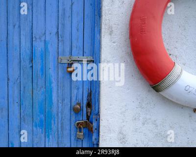 LIFEBUOY AND WEATHERED DISTRESSED BLUE DOOR NEWLYN HARBOUR Stock Photo ...