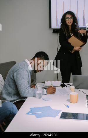 A handsome male business person underlining important parts of the ...