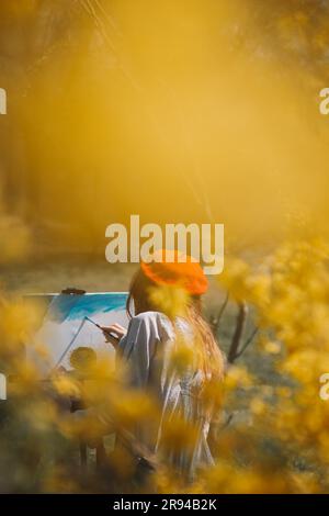 a girl is sitting with an umbrella in yellow boots Stock Photo - Alamy