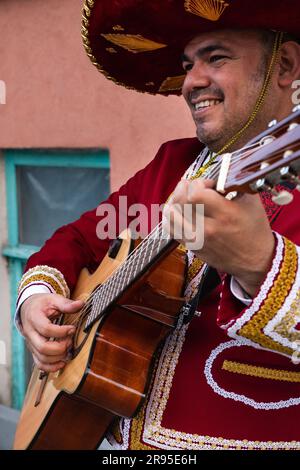 Mexican musician mariachi plays the guitar on a city street Stock Photo ...