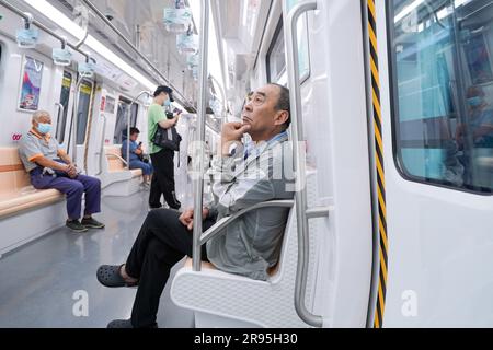Shanghai metro line 11 train emerges from a tunnel near the motor ...