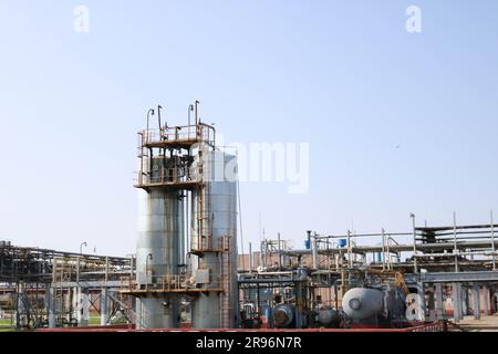 Two huge high metal tanks, barrels, heat exchange equipment, pumps ...