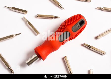 red screwdriver, white background and bits, spare parts Stock Photo - Alamy