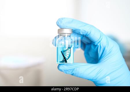 Genetics research. Scientist holding vial with liquid and illustration ...