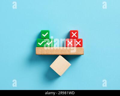 Checkmark and cross symbols on wooden cubes. Making the right choice ...