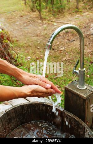 Man's hands under running water in bathroom sink, side view Stock Photo ...