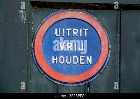 Dutch garage door warning sign. The Dutch text translates as Exit, Keep ...