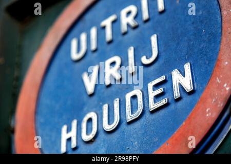 Dutch garage door warning sign. The Dutch text translates as Exit, Keep ...