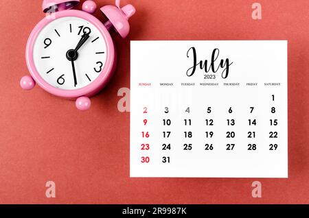 July 2023 Monthly calendar for 2023 year with vintage alarm clock on ...