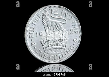 Reverse of a UK 1942 one shilling coin featuring a Lion stood on the ...