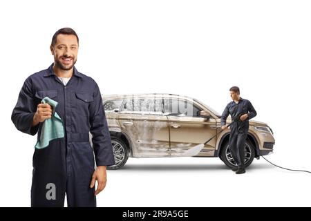 Car wash manager and workers washing a SUV with a pressure washer ...