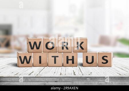 Work with us sign in a bright office environment on a wooden desk Stock ...