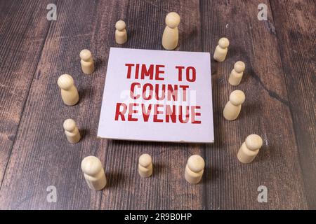 Text Time To Count Revenue on financial tables with pen, glasses and ...