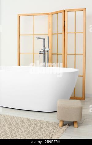 Beautiful white tub and ottoman in bathroom. Interior design Stock ...