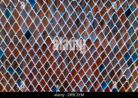 Wall fragment with medieval ceramic tiles in diamond scale shape ...