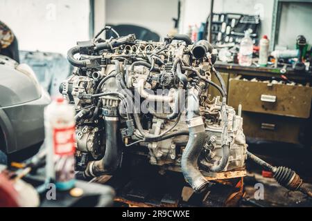 disassemble the engine from the car in the car workshop Stock Photo - Alamy