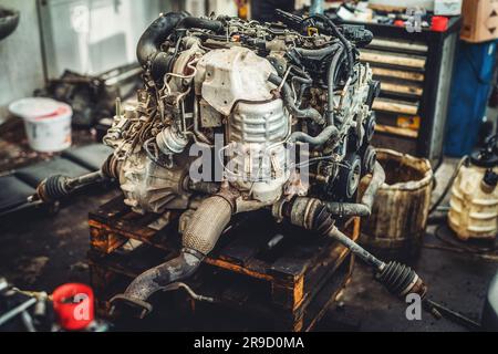 disassemble the engine from the car in the car workshop Stock Photo - Alamy
