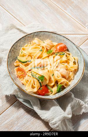 Fettuccine pasta with shrimp, cherry tomatoes, sauce, spices and herbs ...