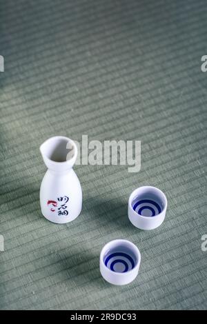 sake cups and bottle , sake is a japanese liquor made from fermented ...