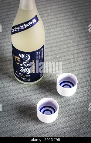 sake cups and bottle on tatami room floor matt , sake is a japanese ...